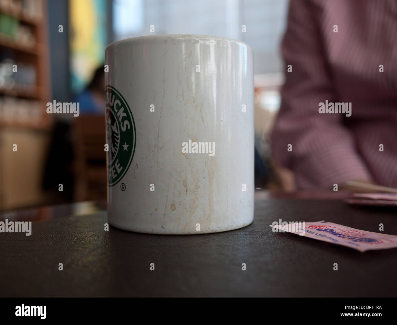 coffee stained mug of on a table with packet of sweetener Stock Photo ...