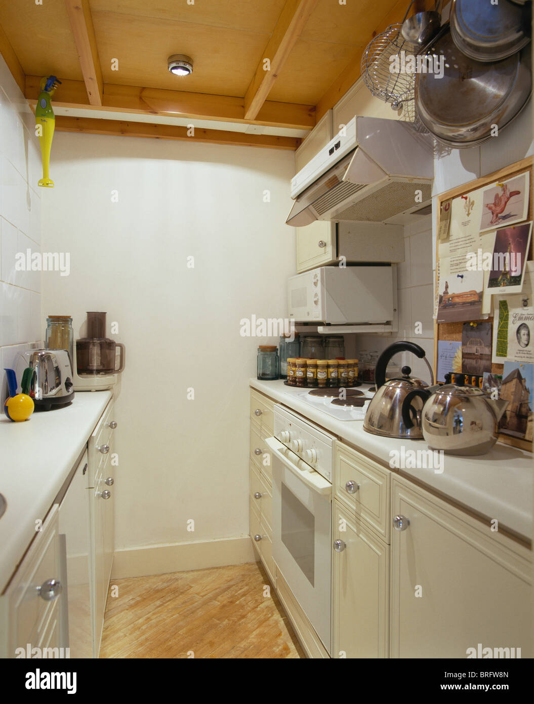 Small white galley kitchen with stainless steel kettle on worktop Stock ...