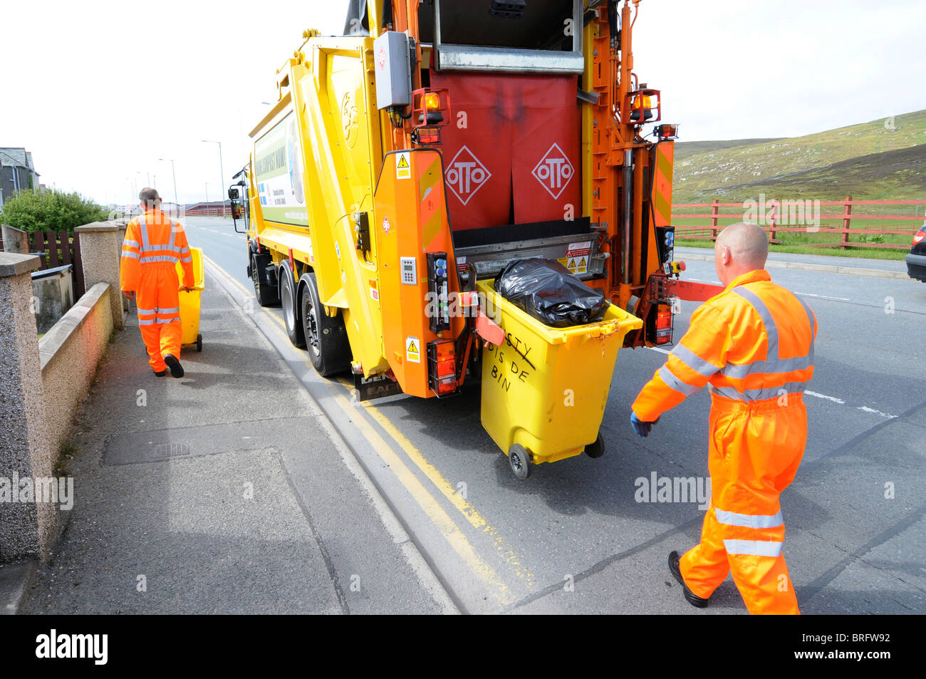 Dustmen collecting rubbish with wheelie bins Stock Photo - Alamy