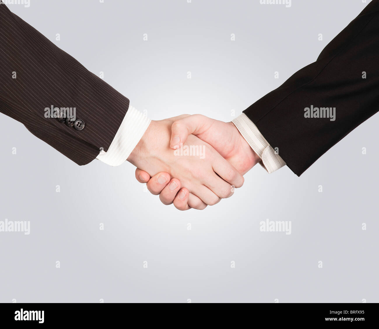 Two businessmen shaking hands Stock Photo - Alamy
