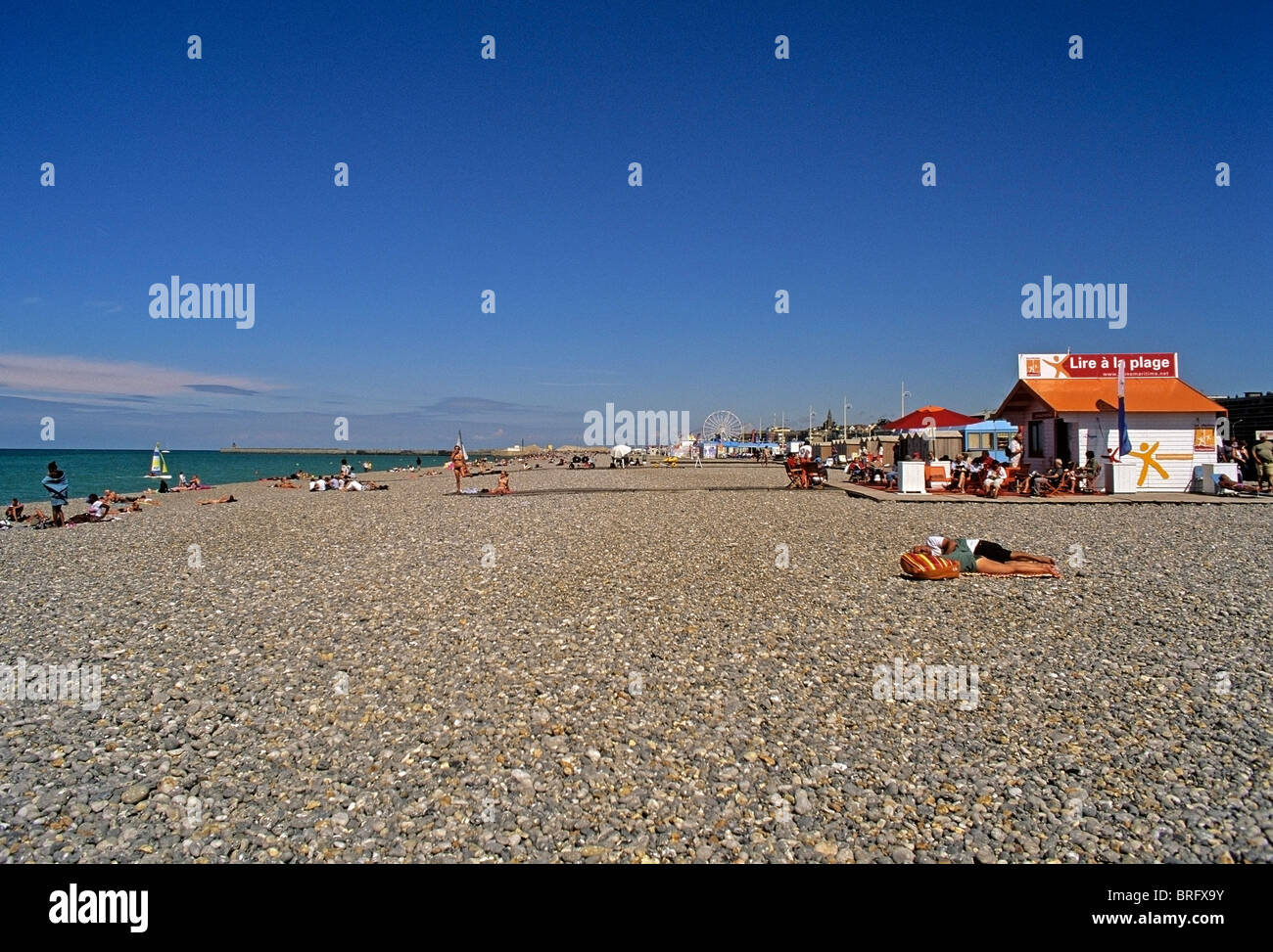 Wide shingle beach shelves steeply into the sea on the North Normany ...