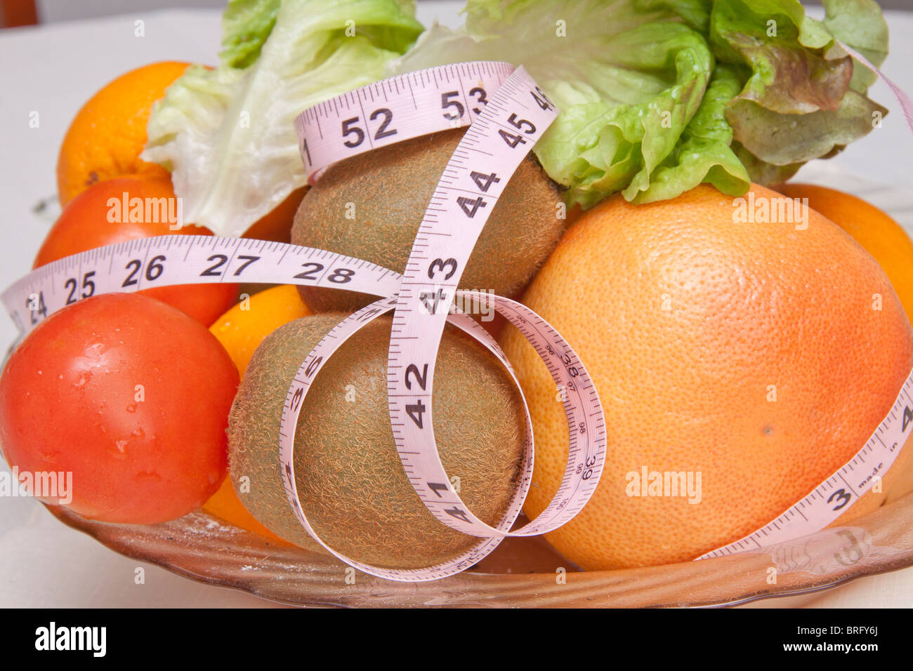 diet concept.tape measuring wrapped around fresh fruits Stock Photo - Alamy