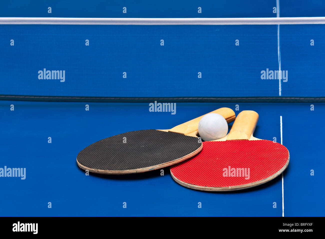 Pair of table tennis rackets on top of a blue playing field Stock Photo ...