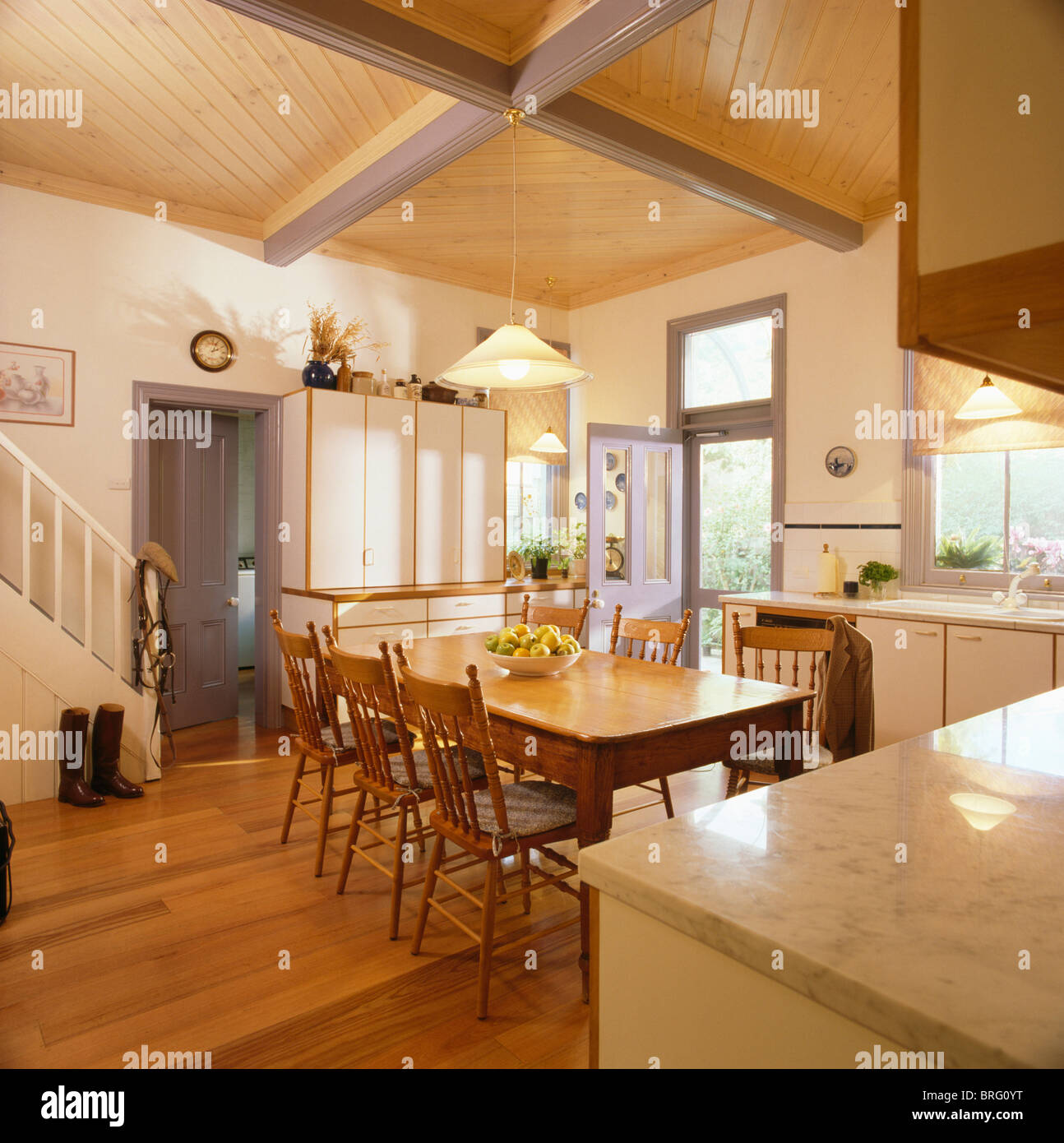 Old pine table and chairs in large country kitchen with wooden floors ...