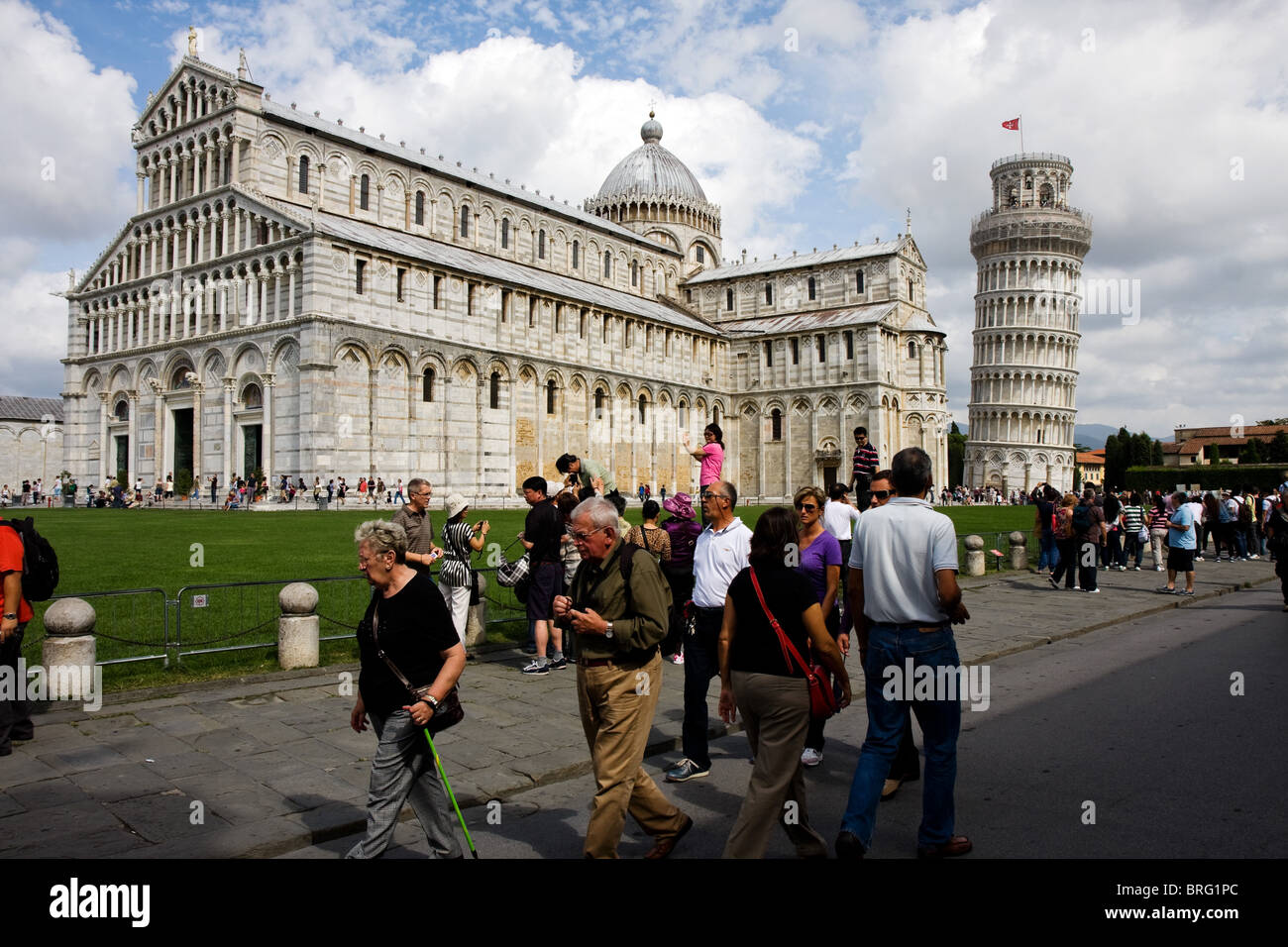 Tourists flock around the Cathedral and Leaning Tower of Pisa in ...
