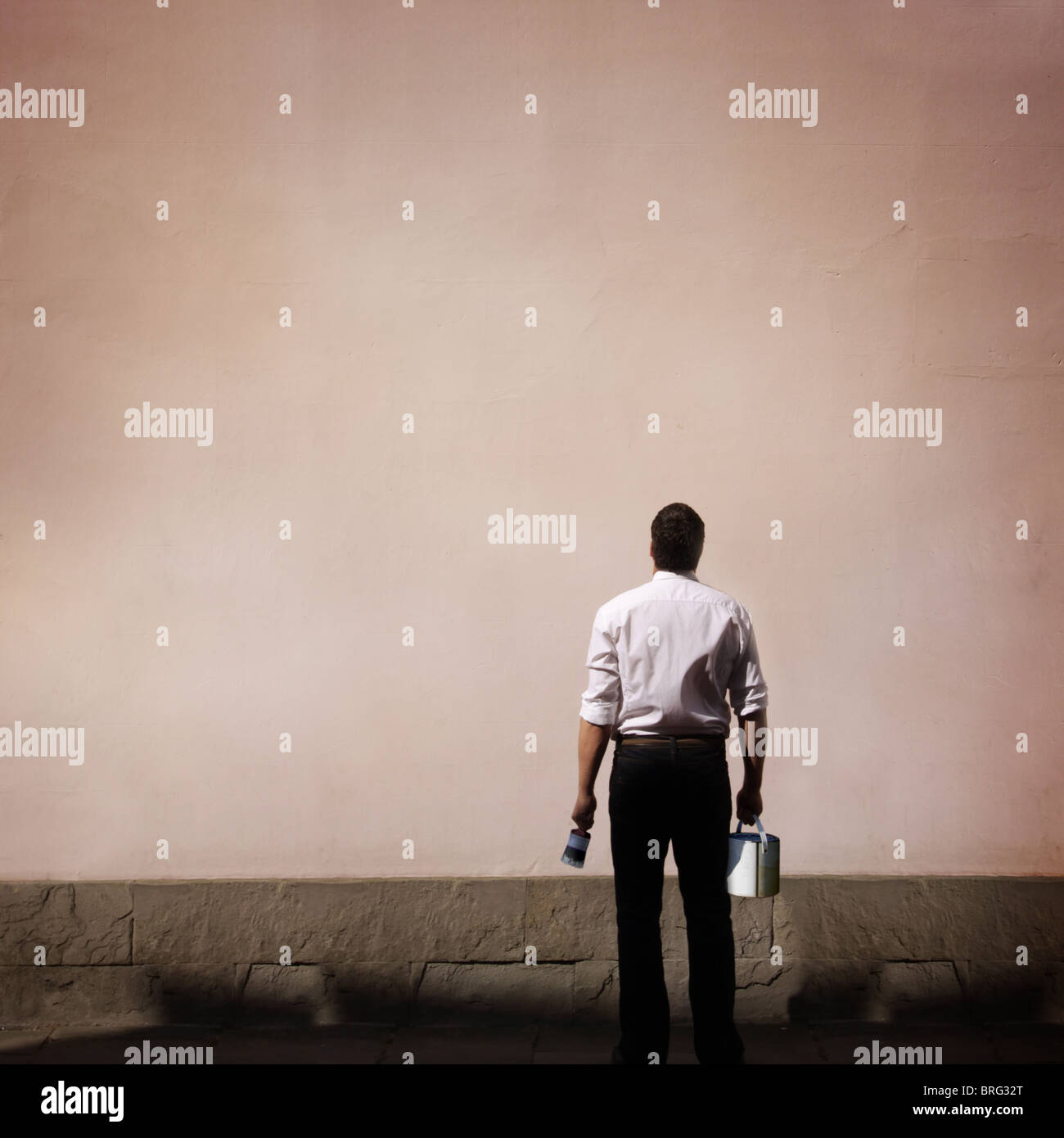 man with paint looking at a blank wall Stock Photo - Alamy