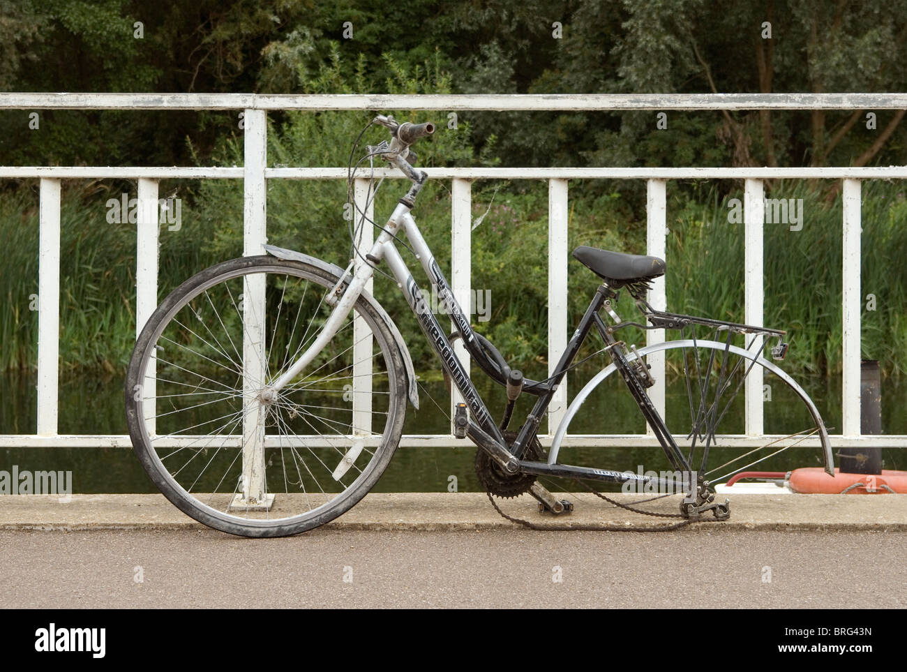 An insecurely parked bicycle with its rear wheel missing Stock Photo ...