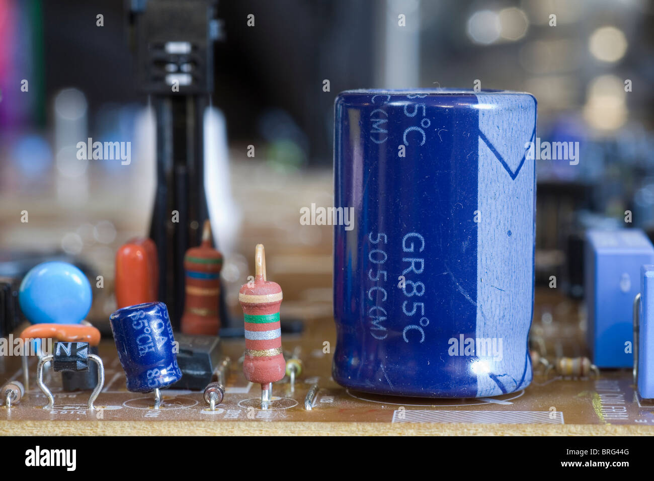 Electrolytic capacitor component on an electronic circuit board next to ...