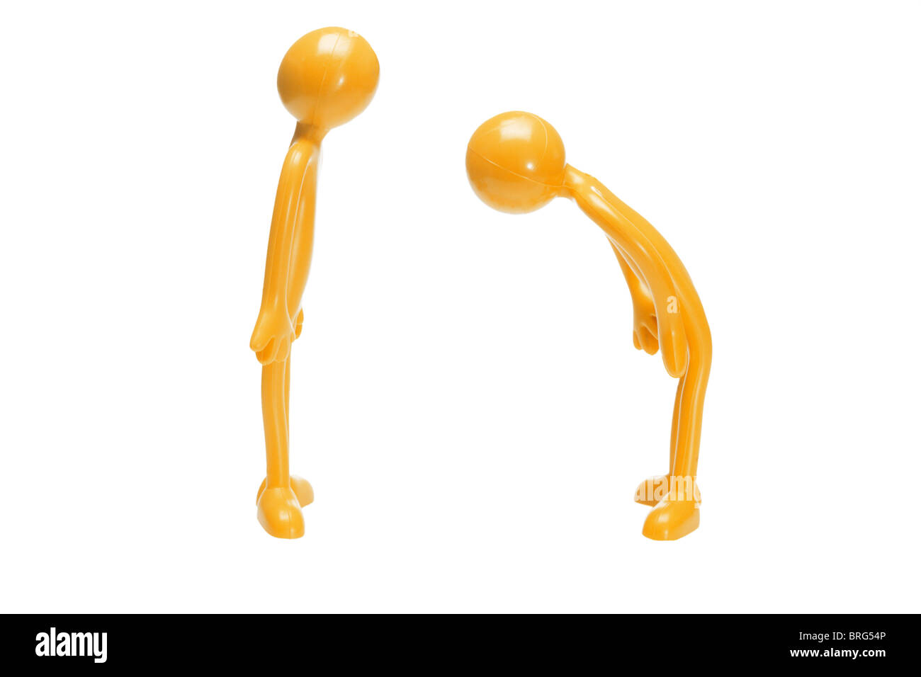 Toy rubber figurine bowing to another on white background Stock Photo ...