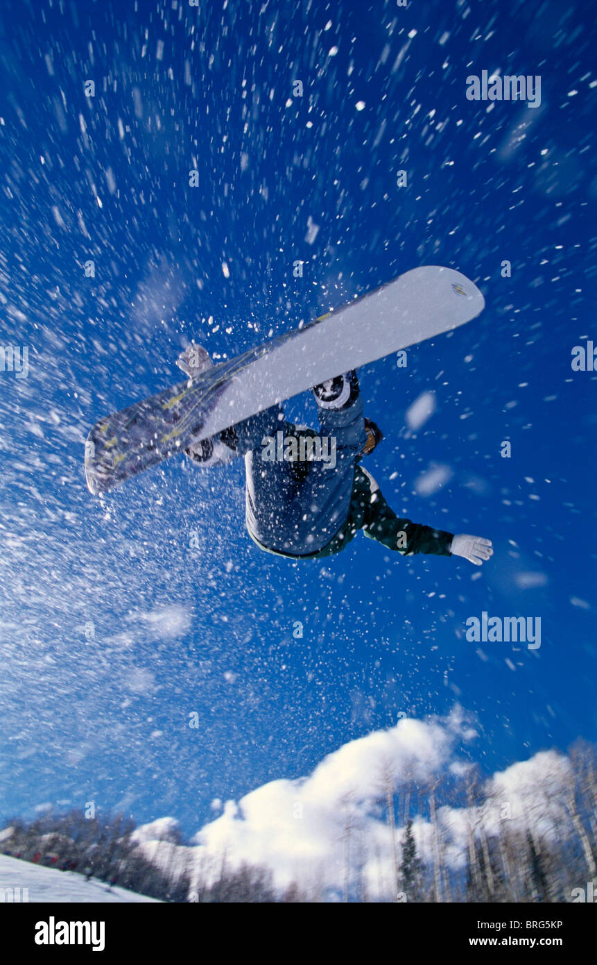 Male snowboarder flying through the air Stock Photo - Alamy