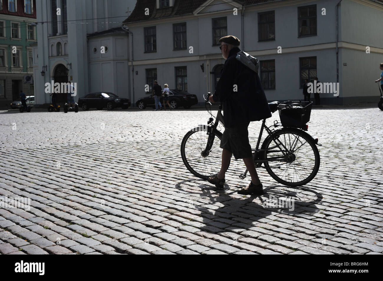 Man walking his bicycle Stock Photo - Alamy