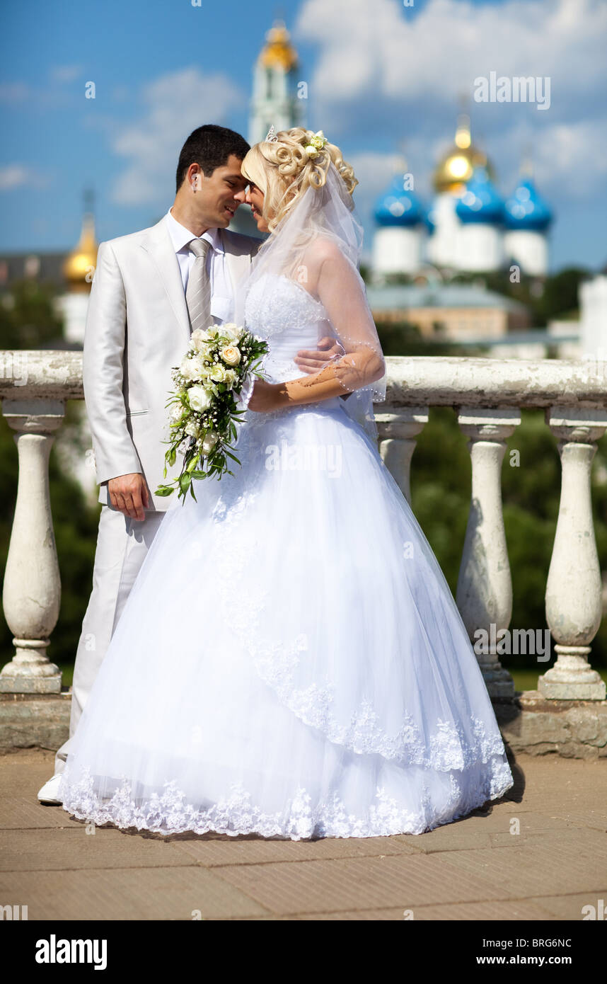 Young couple wedding. Standing at the railing Stock Photo - Alamy