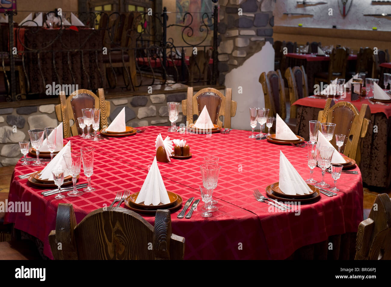 round laid table in a restaurant of medieval castle design Stock Photo ...