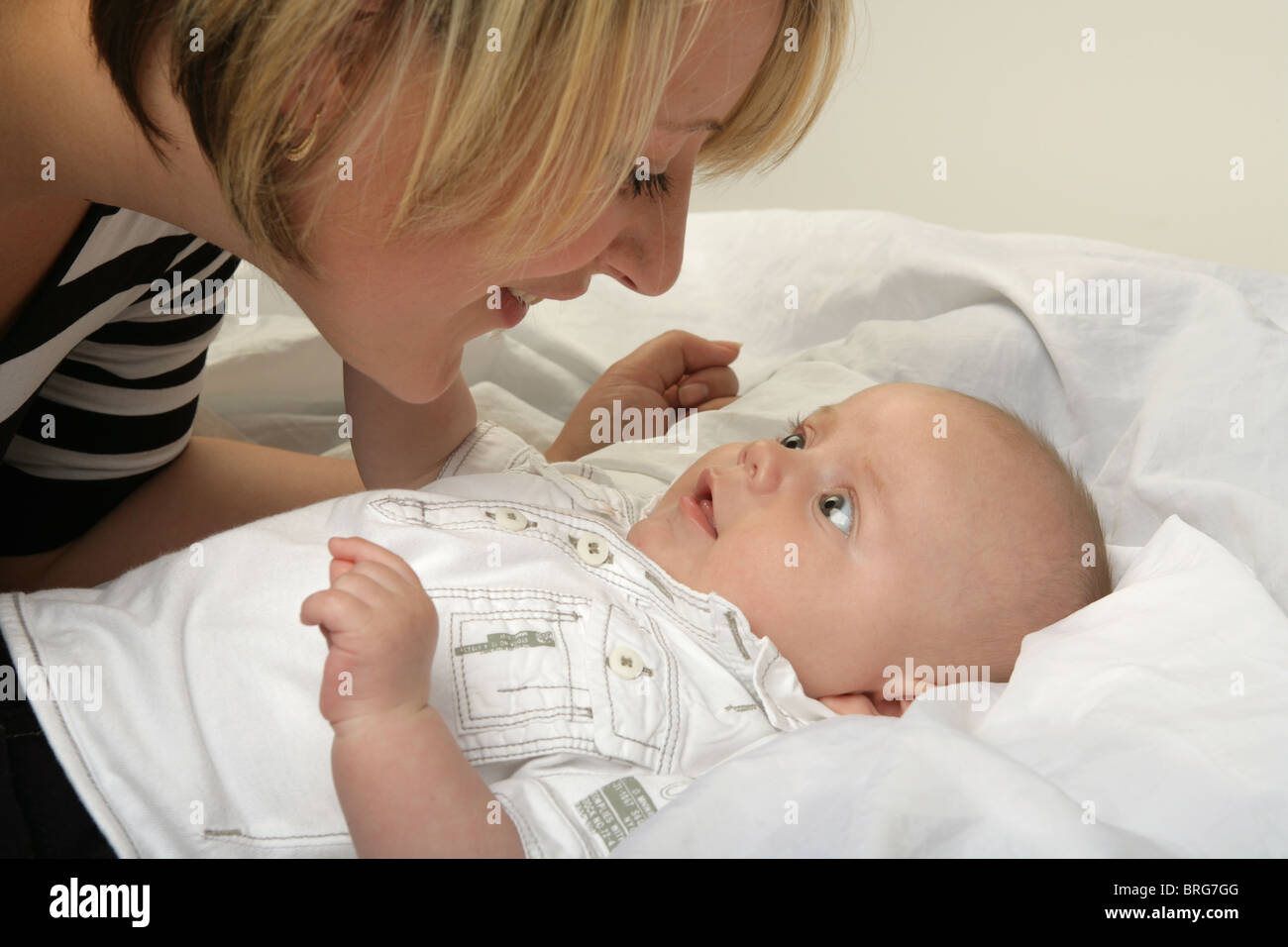 Mother looking closely at her baby hi-res stock photography and images ...
