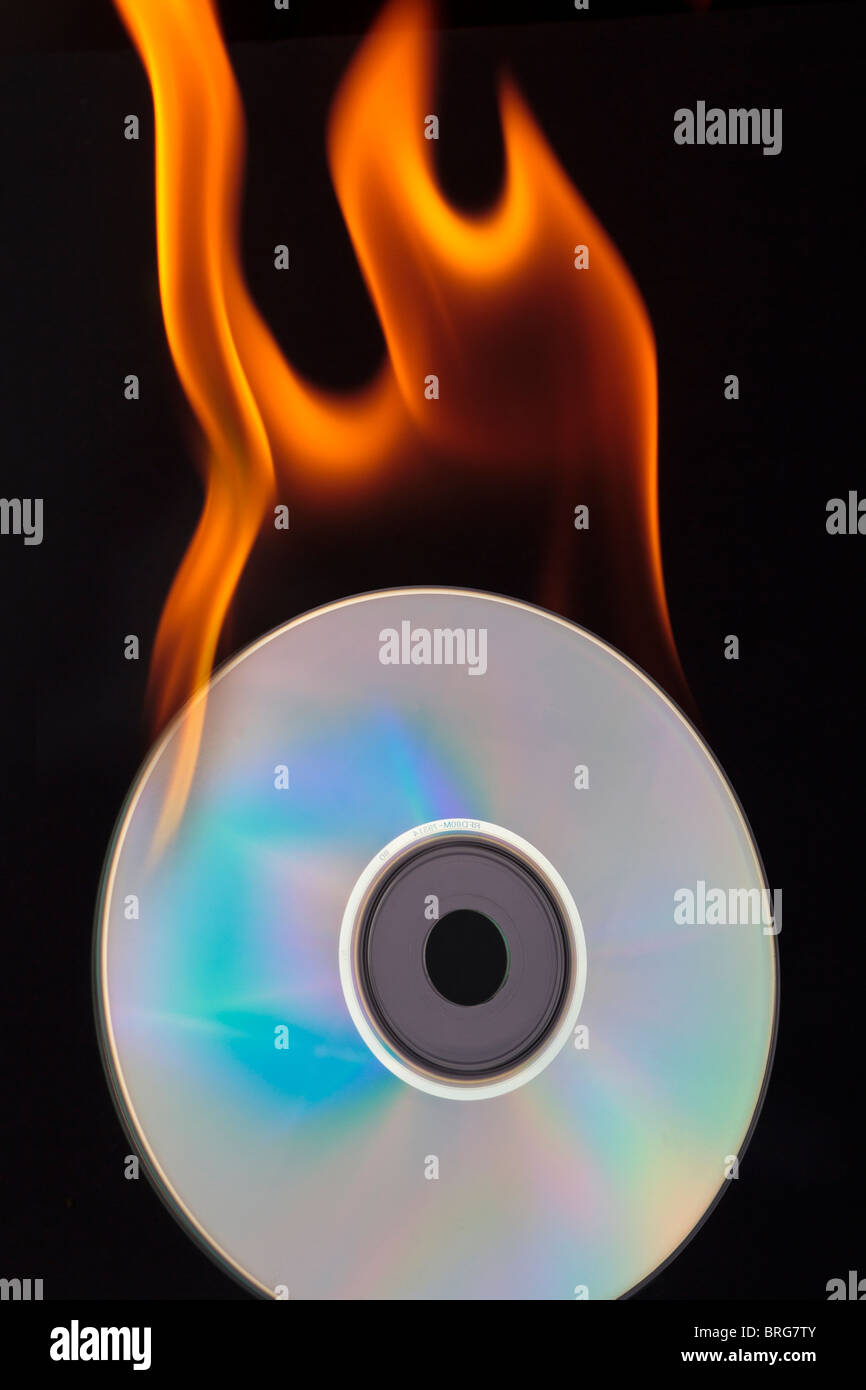 Cd burning on the black background Stock Photo - Alamy