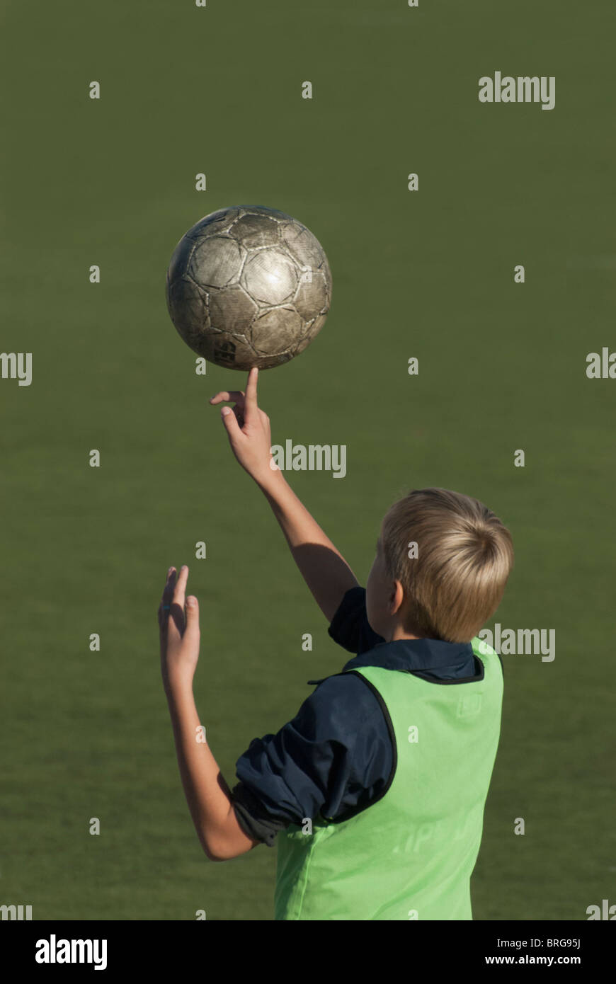 Little boy keeping the ball on his finger Stock Photo - Alamy