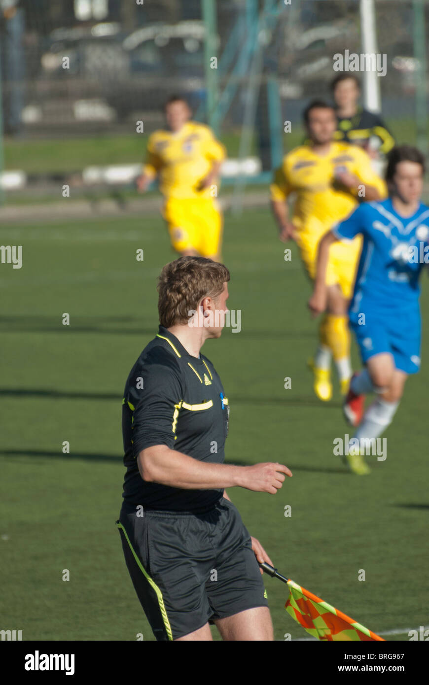 Side referee running along of the pitch border Stock Photo - Alamy