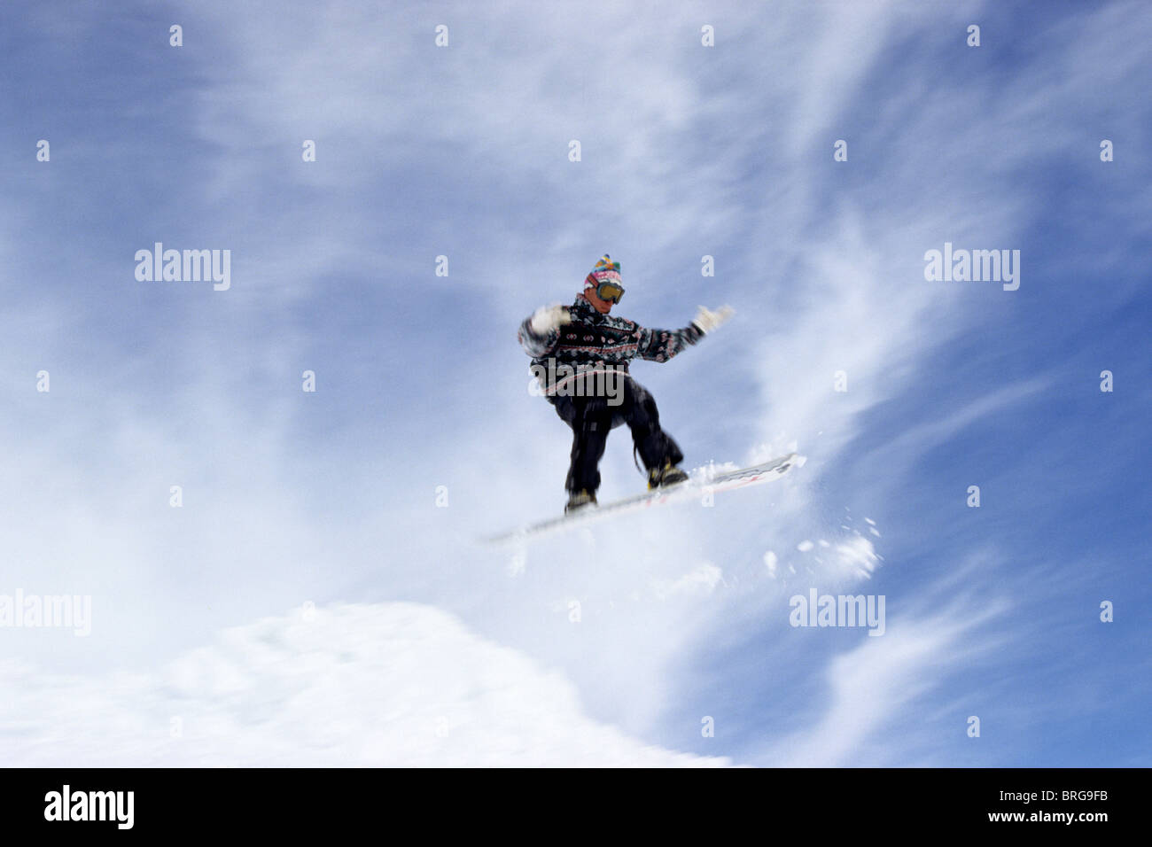 Snowboarder flying through the air Stock Photo - Alamy