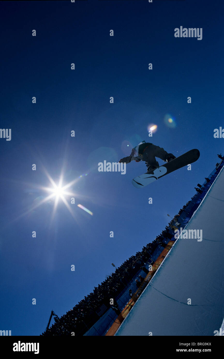 Female snowboarder flying over the vert Stock Photo - Alamy
