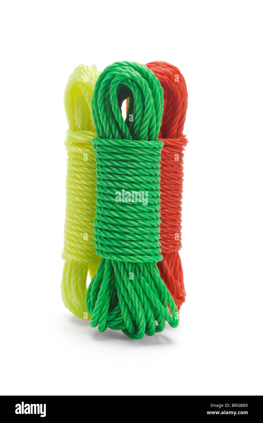 Three bundles of colorful nylon ropes standing together on white ...