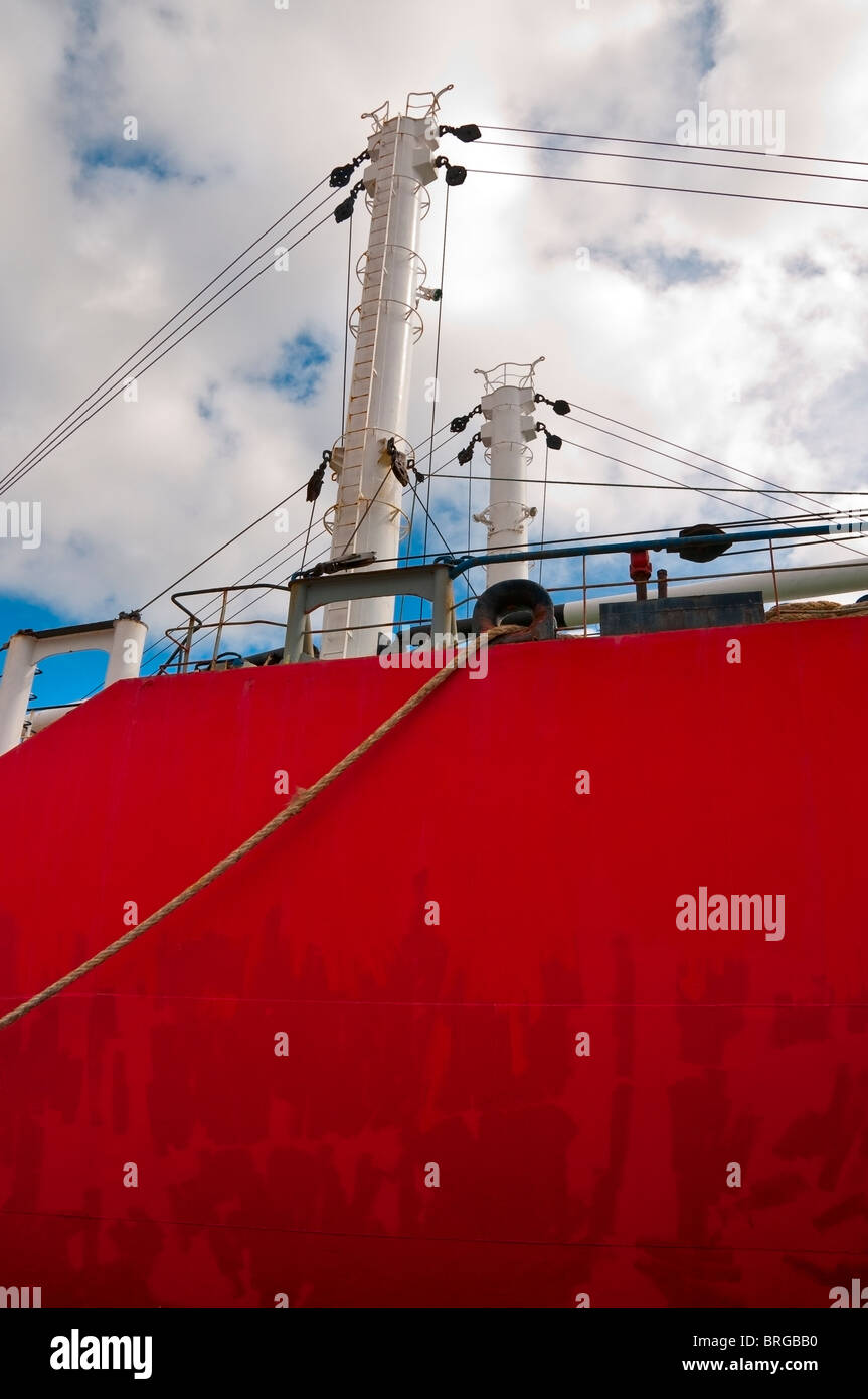 Hull and masts of a red old freighter with pulleys Stock Photo - Alamy