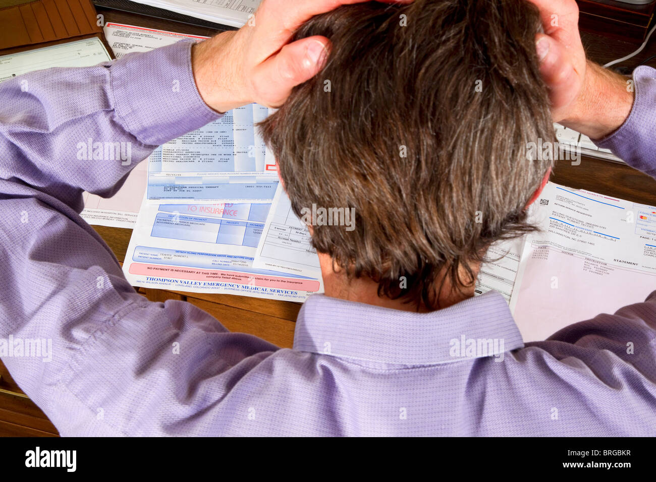 Frustrated man paying bills doing paperwork finances Stock Photo - Alamy