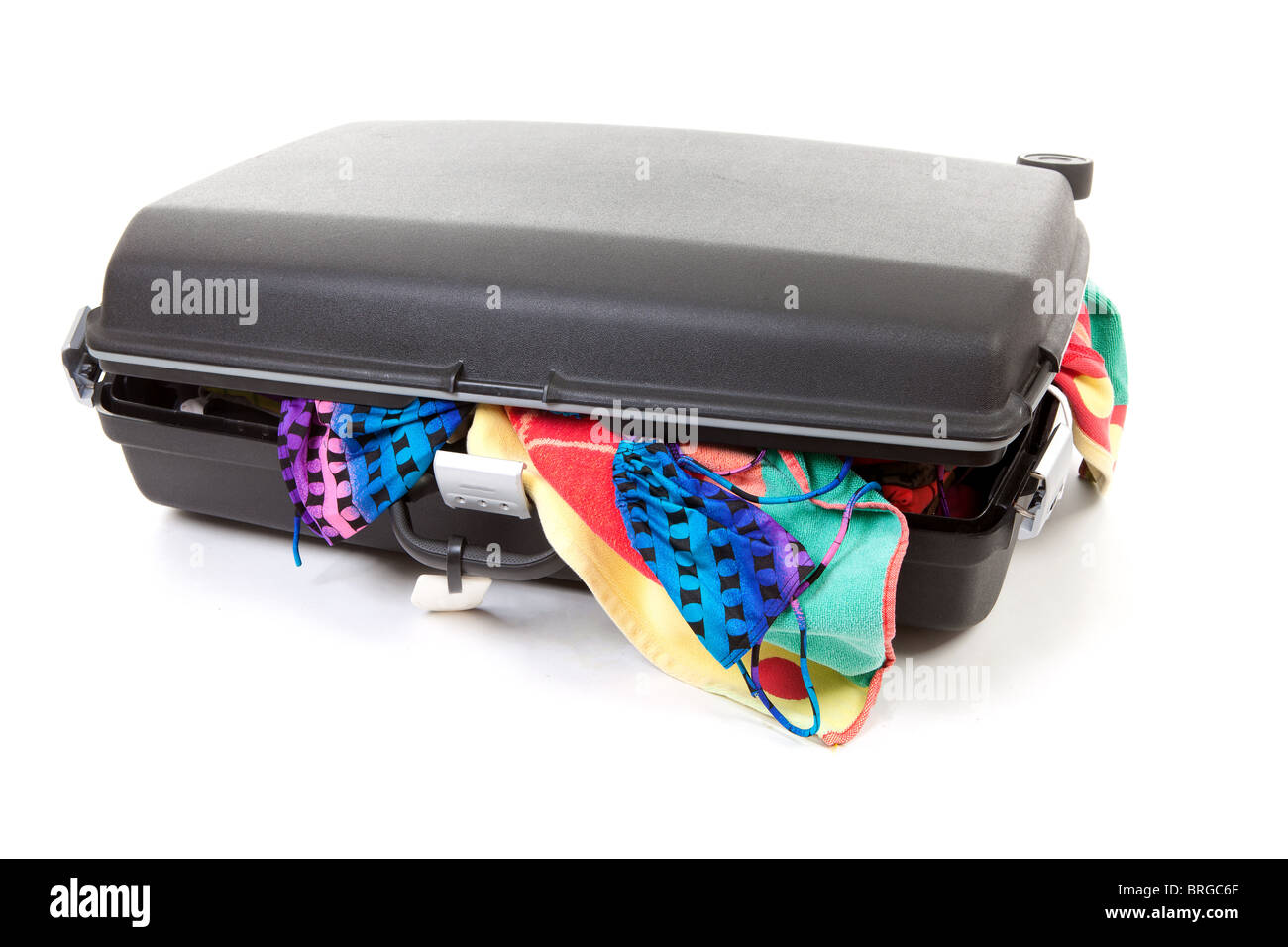 stuffed suitcase for vacation over white background Stock Photo - Alamy