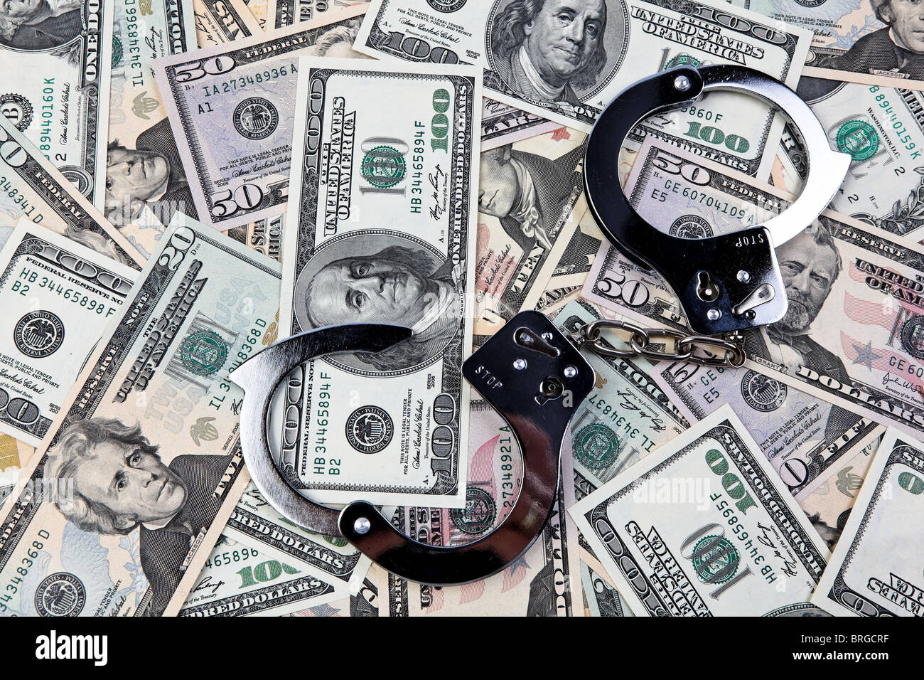 Symbol of economic crime. U.S. dollars bank notes and handcuffs Stock ...