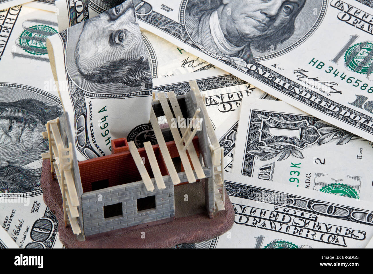 A shell construction house. Funding with dollar bills Stock Photo - Alamy