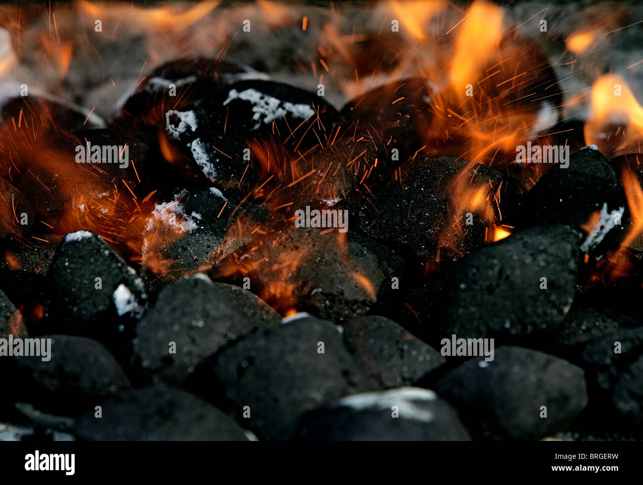 burning charcoal biscuits set on fire in a barbecue grill Stock Photo ...
