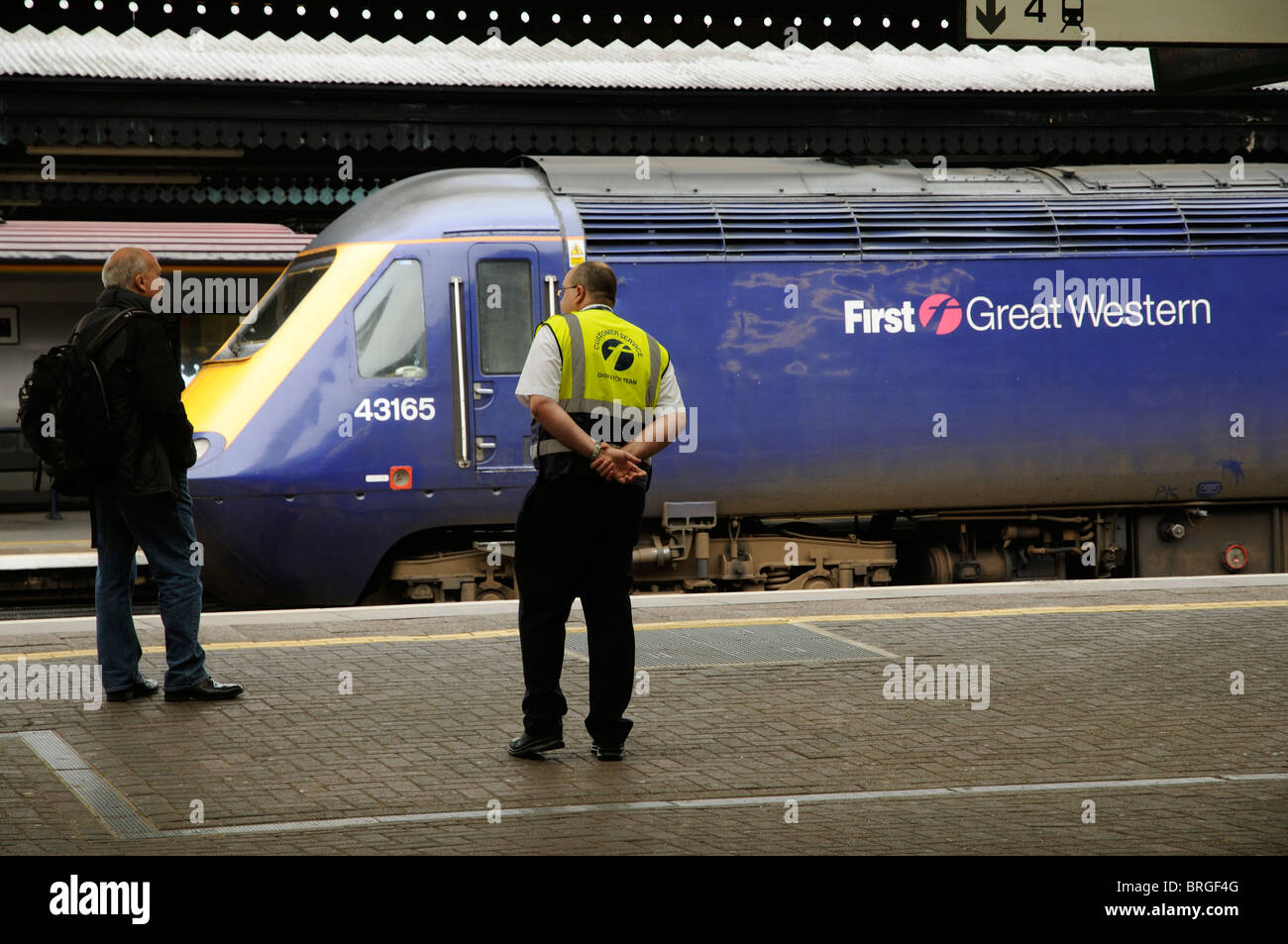 Railway station and train with a Customer Service dispatcher standing ...
