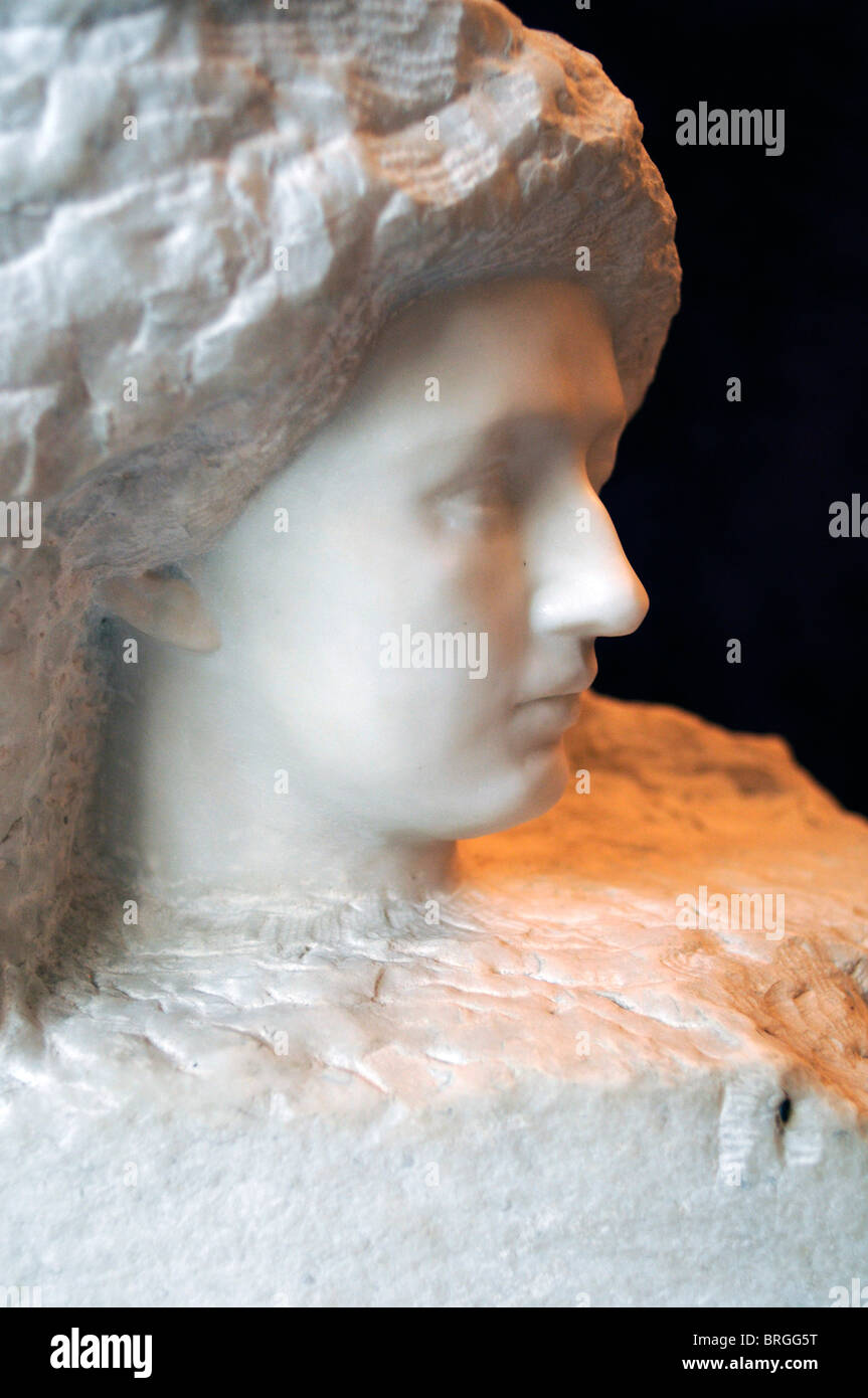 A woman face carved out of stone, a work in progress on display inside ...