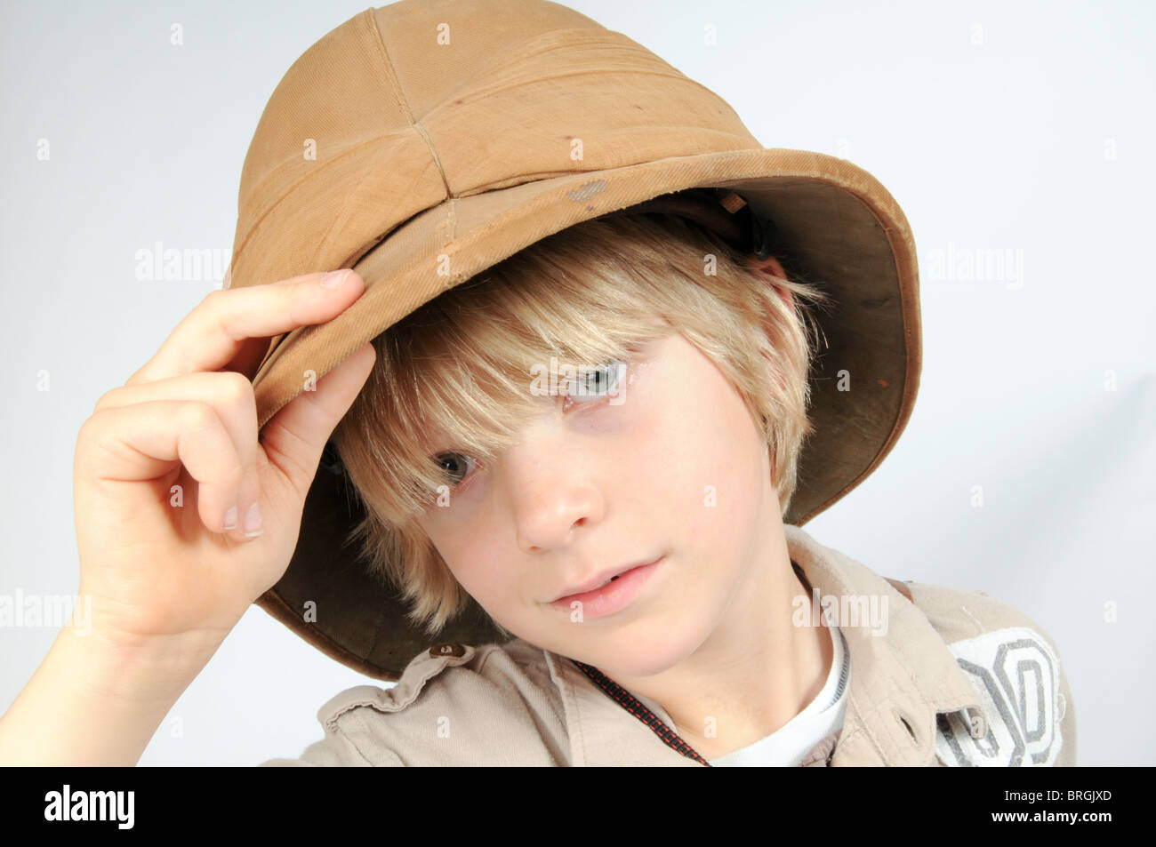 Young boy dressed up as a Victorian explorer wearing a pith helmet ...