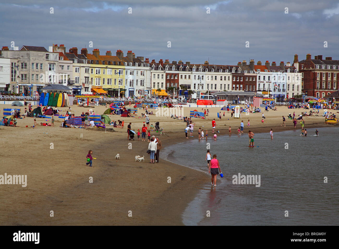 The sandy beach and colourful seafront terraces at Weymouth Dorset ...