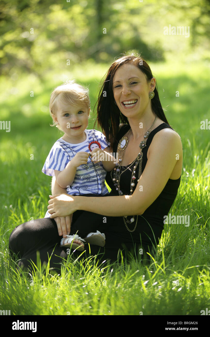 Mother sitting with her child outside on a sunny day Stock Photo - Alamy