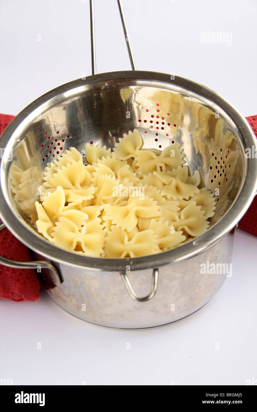 Boiled pasta in a pot on a white background Stock Photo - Alamy