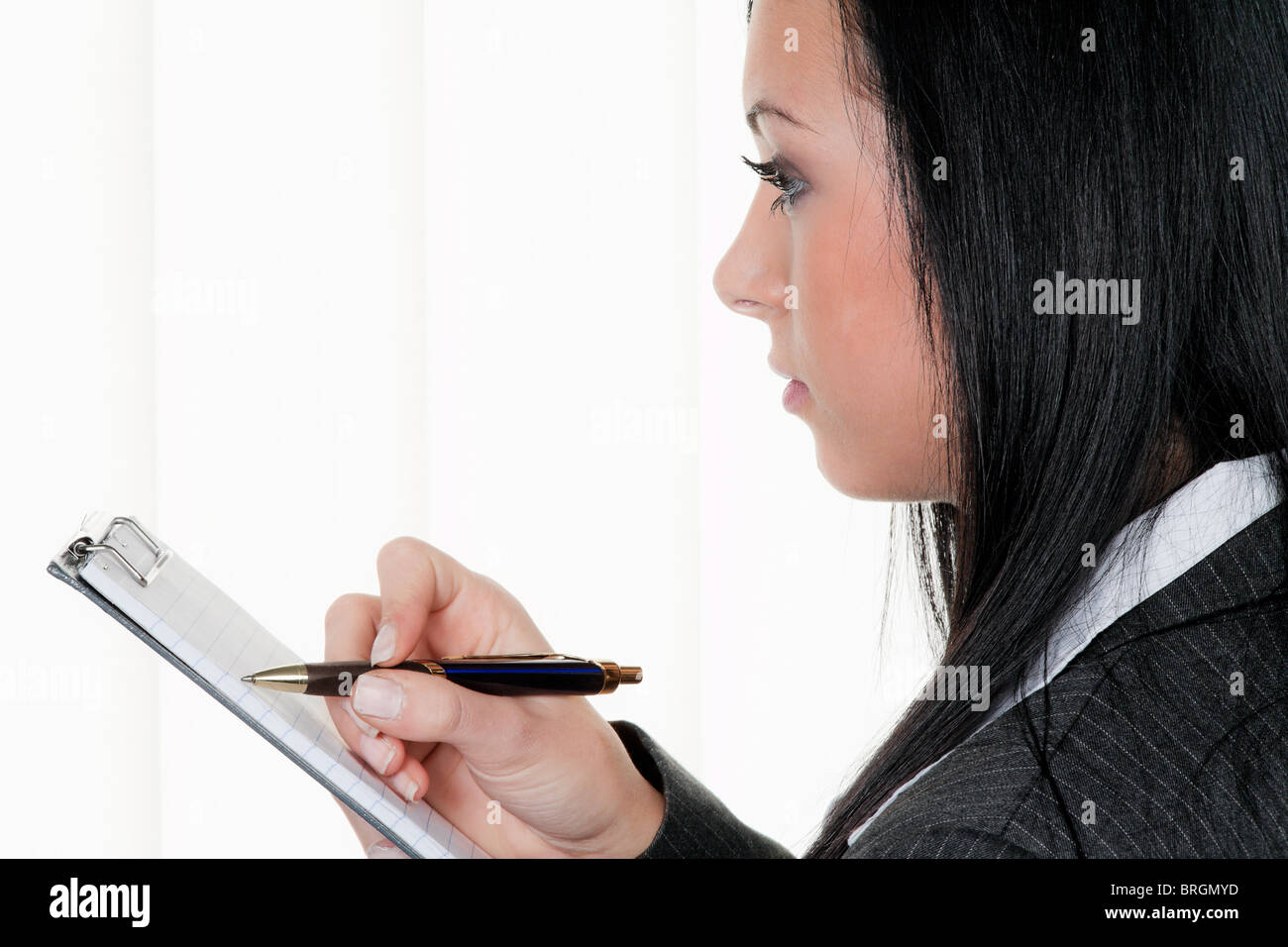 Manager with clipboard at controlling takes notes Stock Photo - Alamy