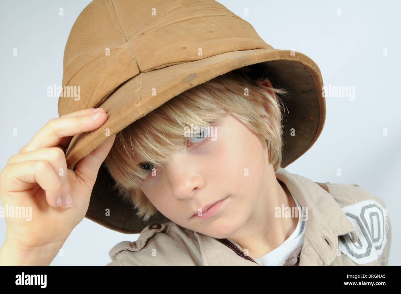 Young boy dressed up as a Victorian explorer wearing a pith helmet ...