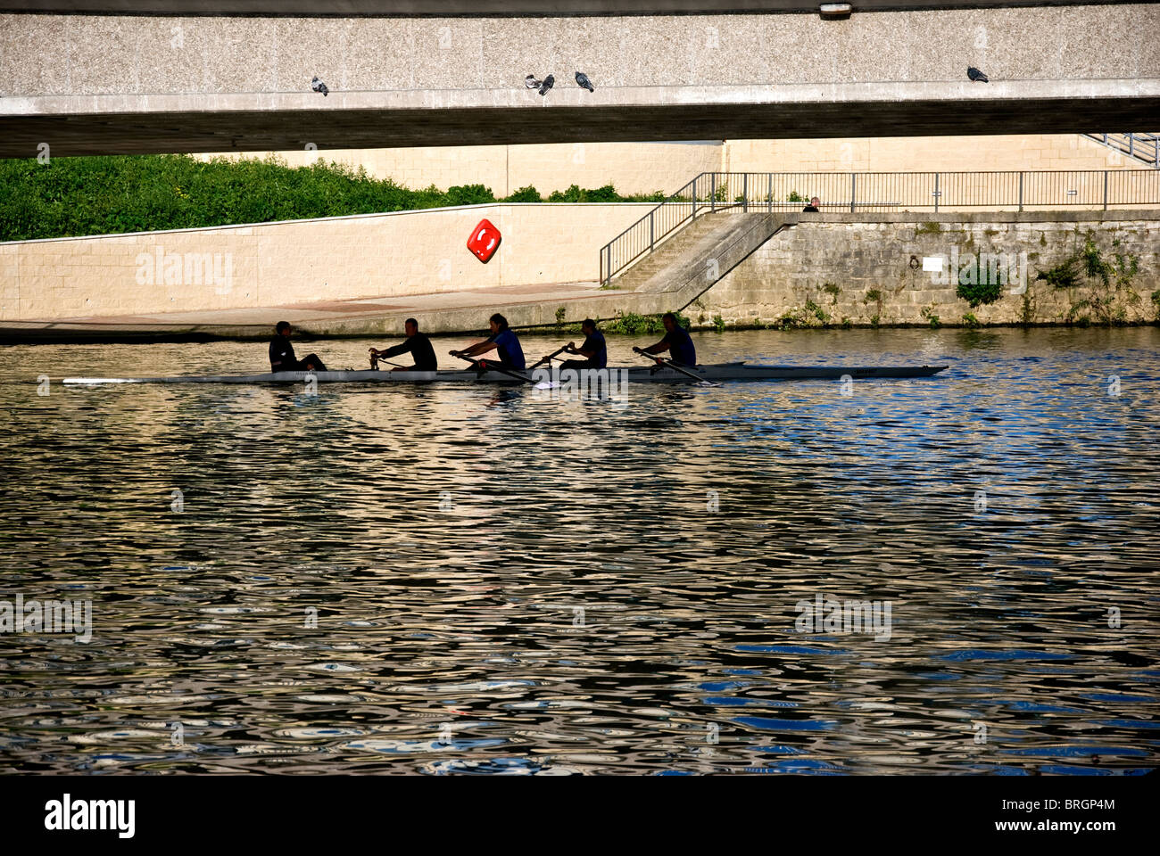Rowing under a bridge Stock Photo - Alamy