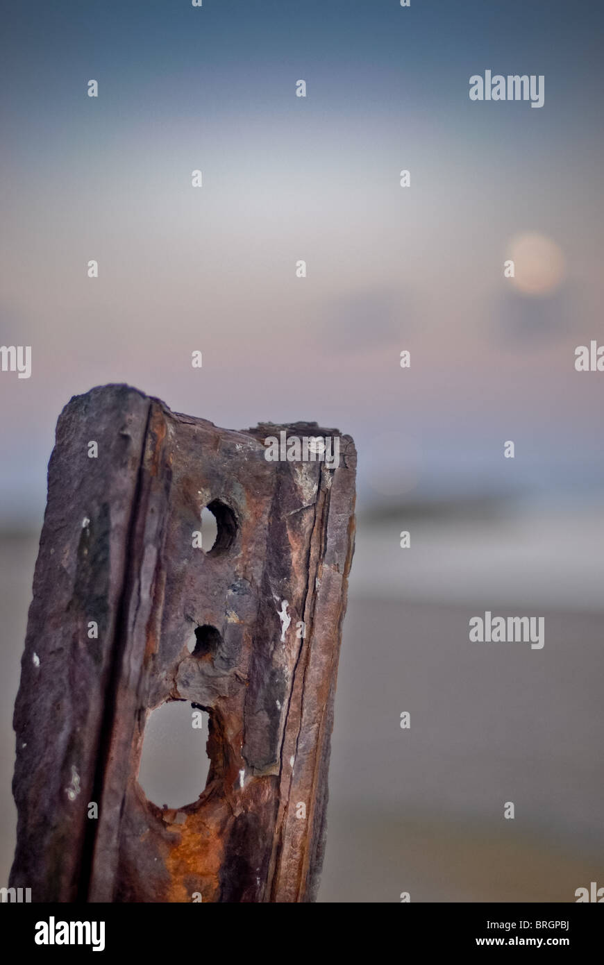 Rusty metal post by sea Stock Photo - Alamy