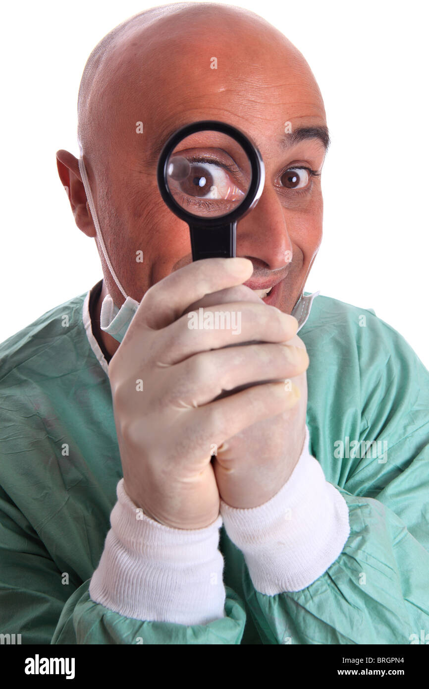 A doctor on forties looking through a magnifying glass Stock Photo - Alamy