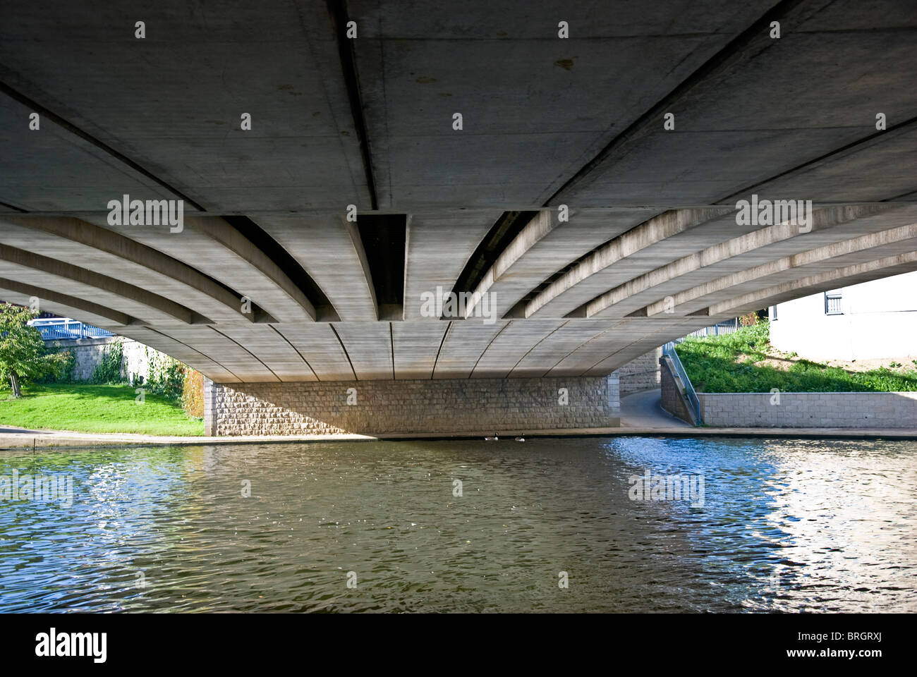 River flowing under a concrete bridge Stock Photo - Alamy