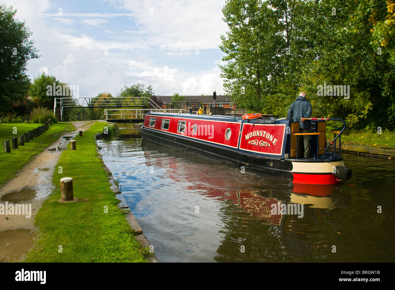A canal narrowboat waiting while a swing bridge is opened on the Ashton ...