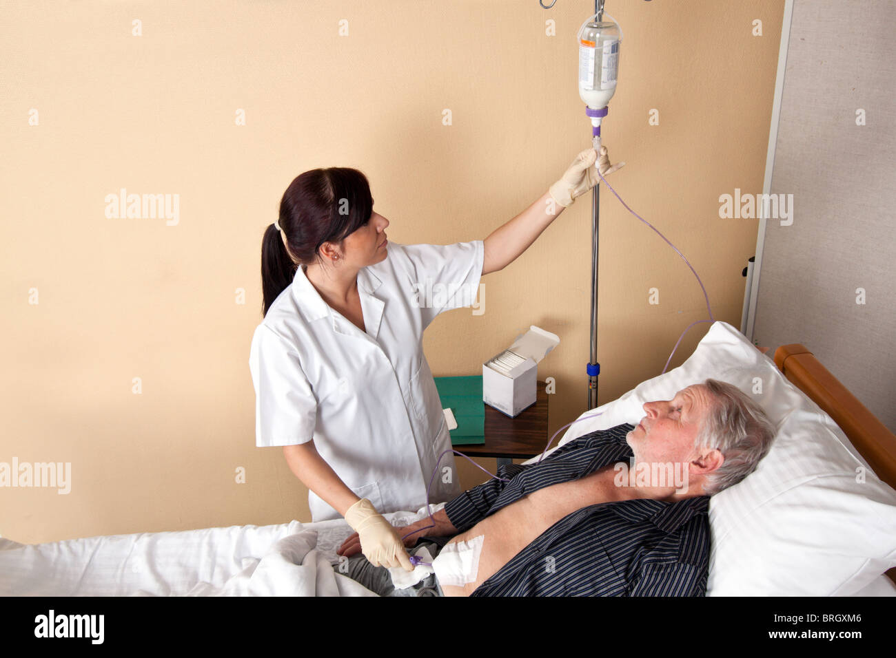A nurse gives an infusion to a patient Stock Photo - Alamy