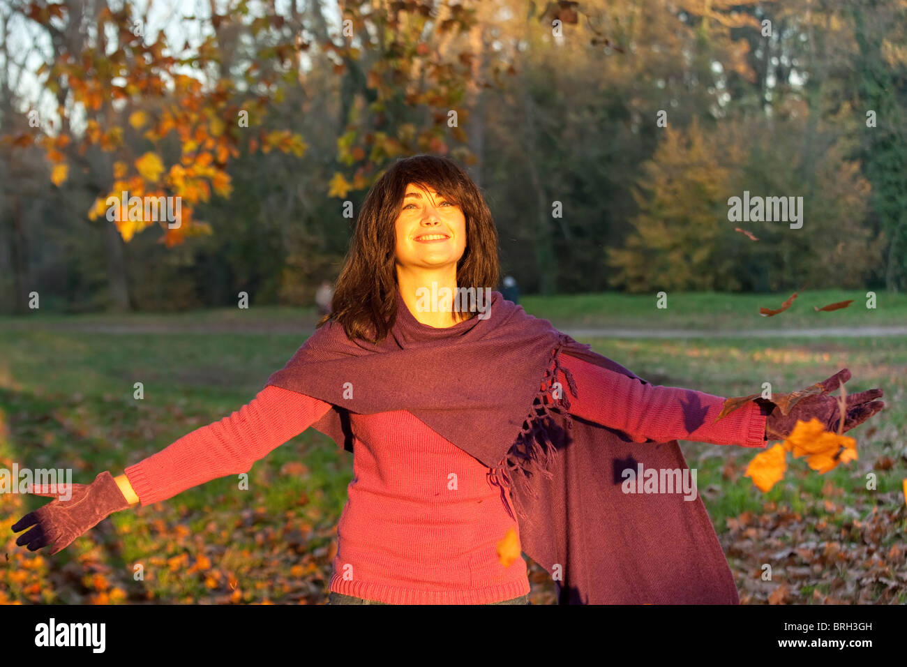 Young woman standing under leaves hi-res stock photography and images ...