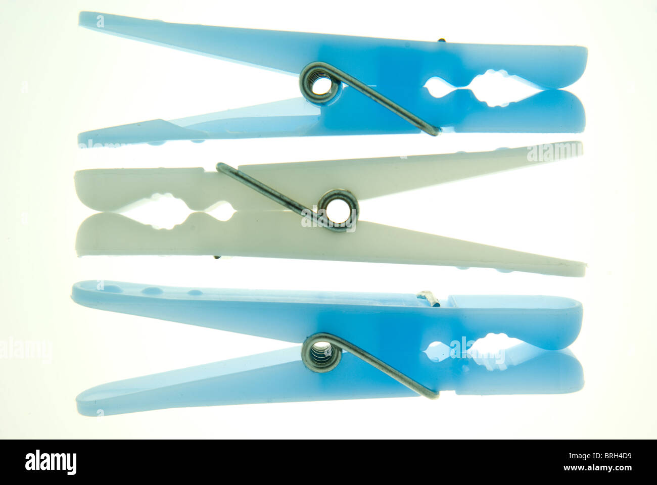 Small Clothes Pegs in white and blue isolated on white background Stock ...
