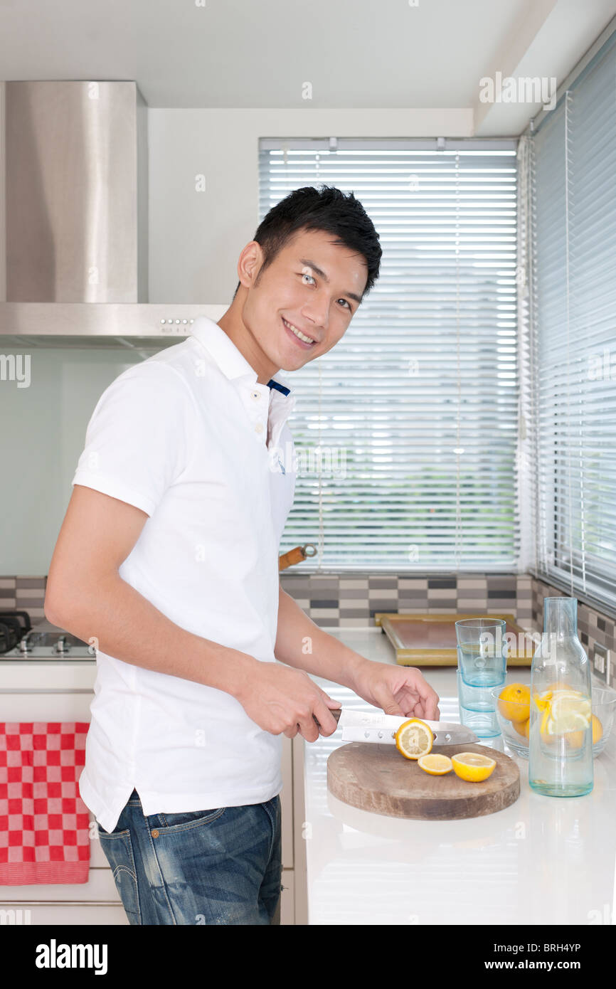 Young man in kitchen Stock Photo - Alamy