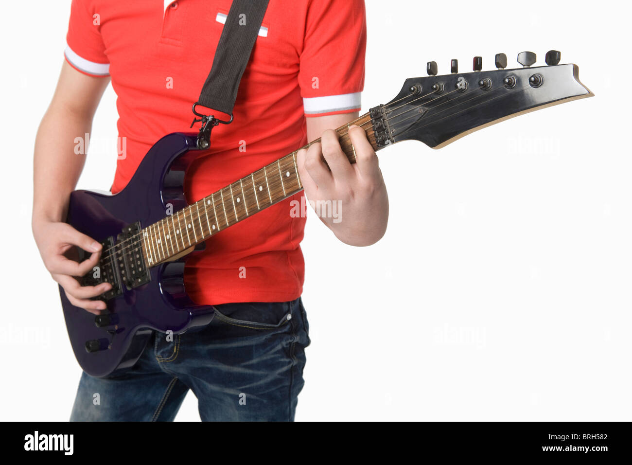 Young man playing an electric guitar Stock Photo - Alamy