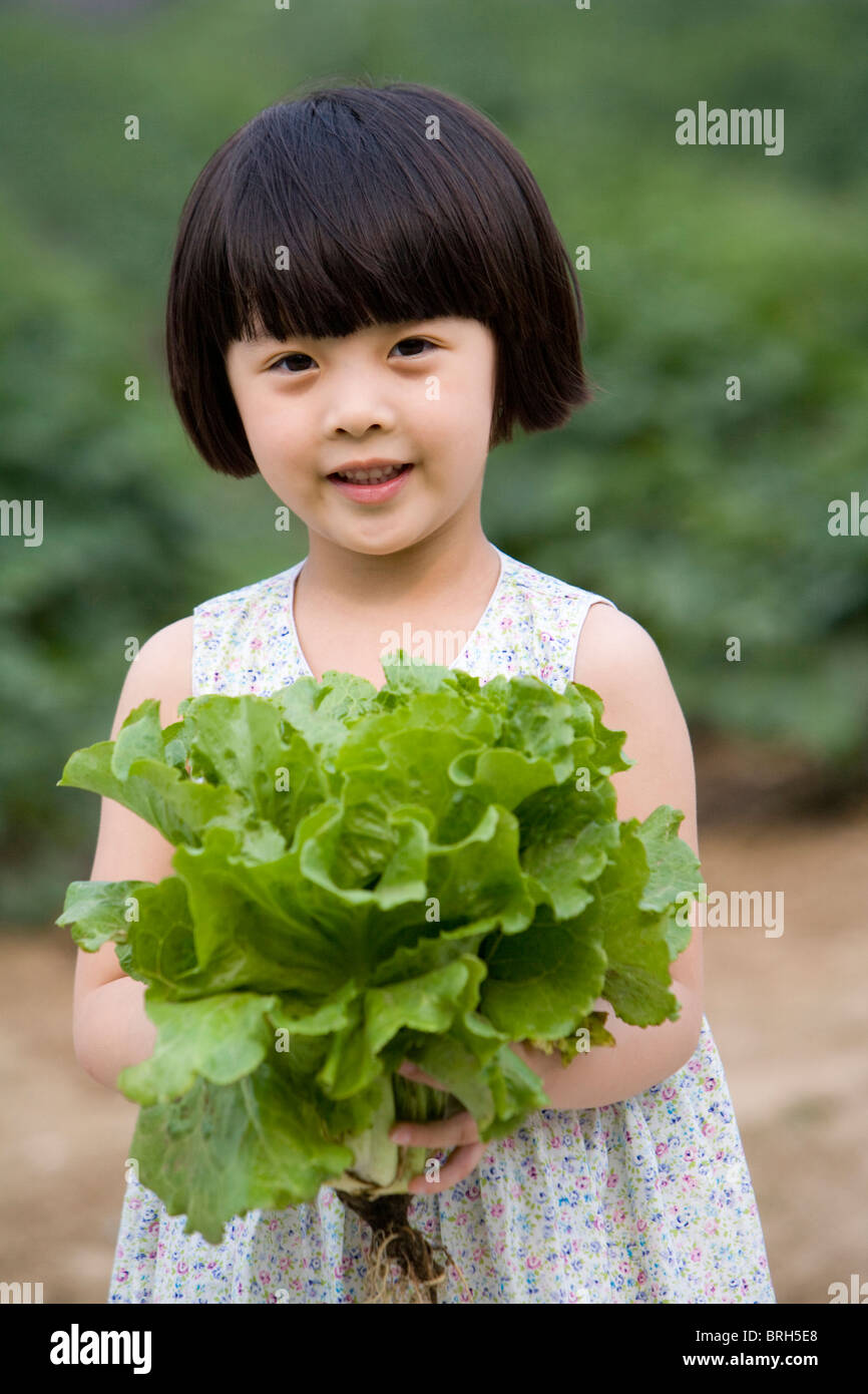 Young girl gardening in farm Stock Photo - Alamy