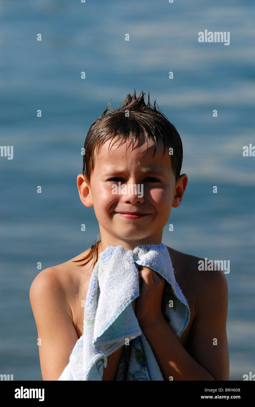 Smiling Boy at the Ocean Stock Photo - Alamy